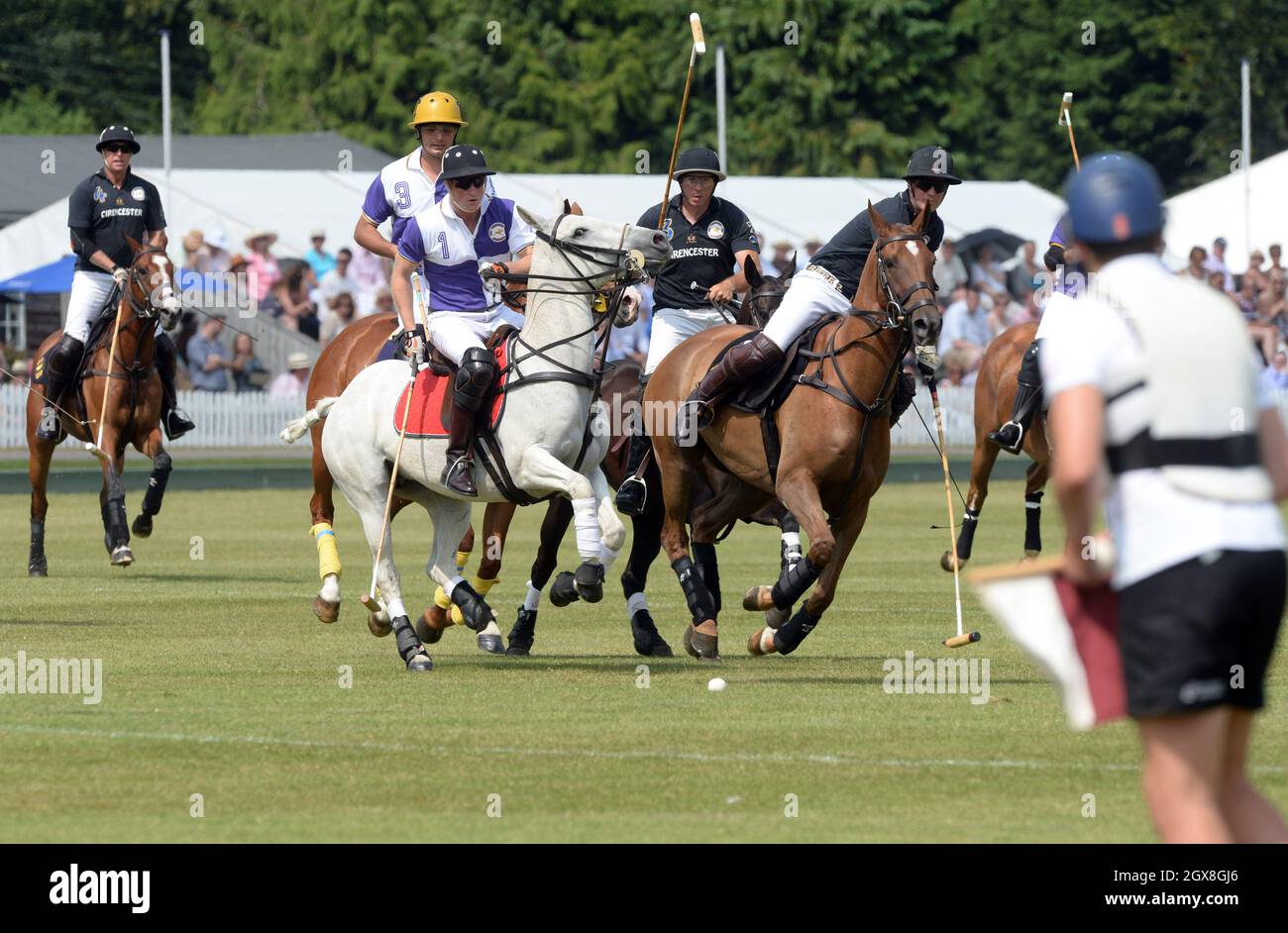 Prince Harry, riding a white horse, takes part in the Jerudong Trophy ...
