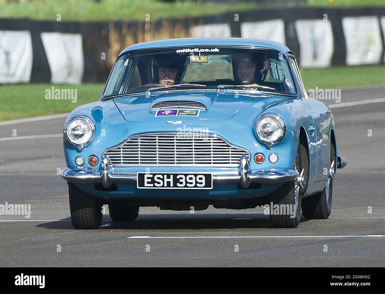 Prince Harry drives a vintage Aston Martin car as he attends The Royal ...