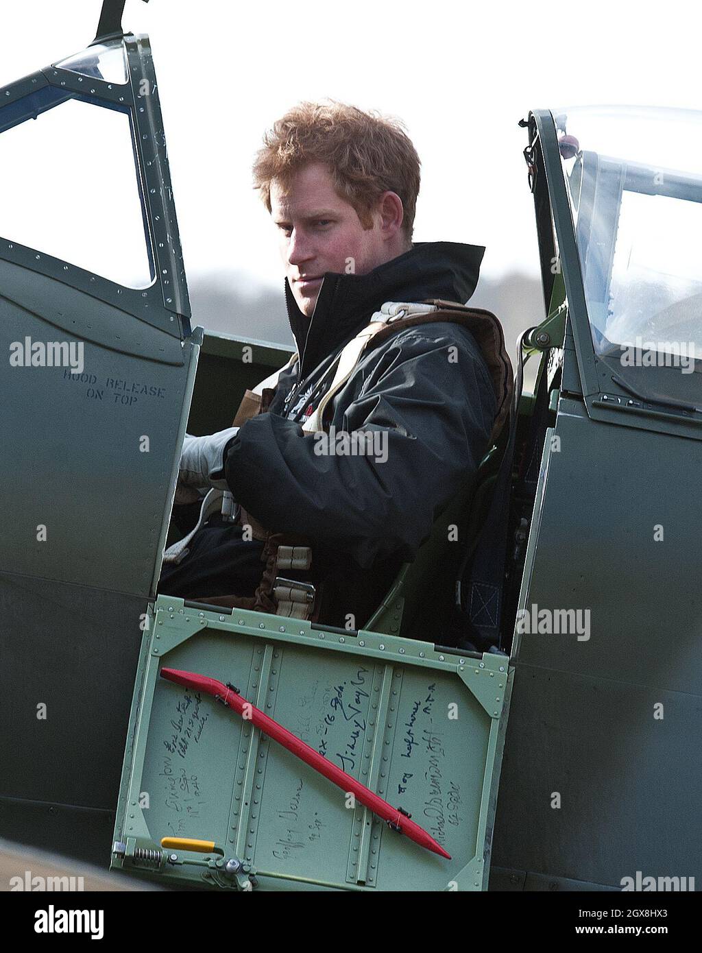 Prince Harry sits in the cockpit of a Spitfire aircraft at the Boultbee ...