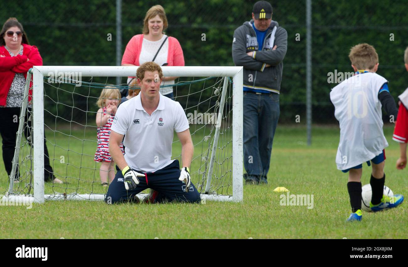 Prince Harry acts a goalie during a football coaching session at ...