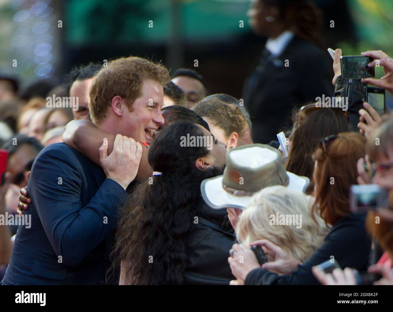 Prince Harry receives a hug from a well-wisher as he arrives for a 50th ...