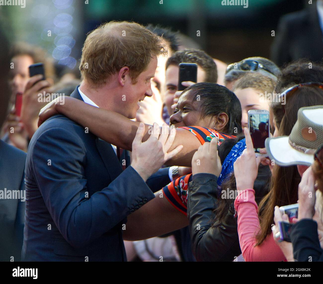 Prince Harry receives a hug from a well-wisher as he arrives for a 50th ...
