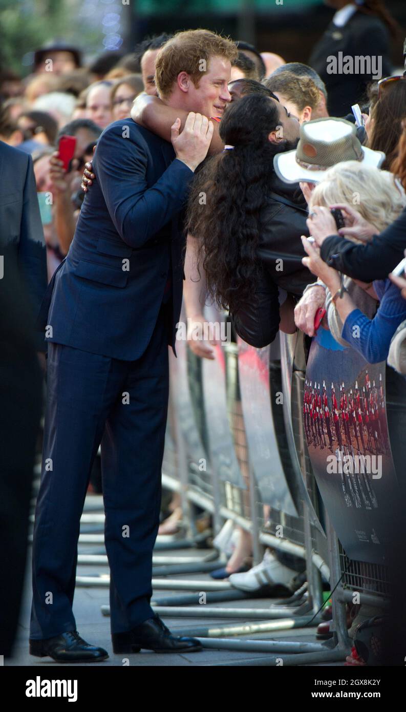 Prince Harry receives a hug from a well-wisher as he arrives for a 50th ...