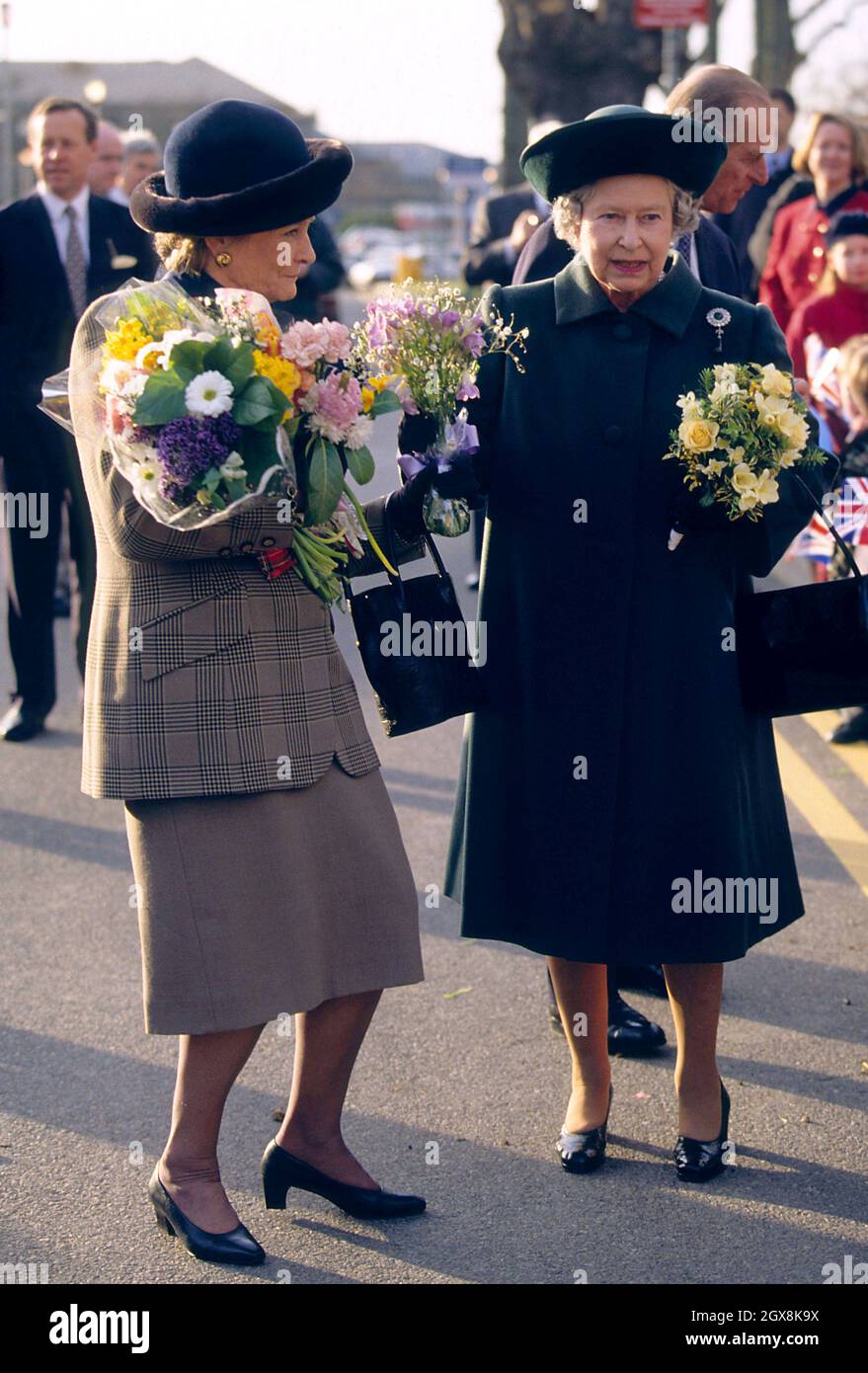 Queen Elizabeth II receives flowers during her visit to Royal Surrey ...