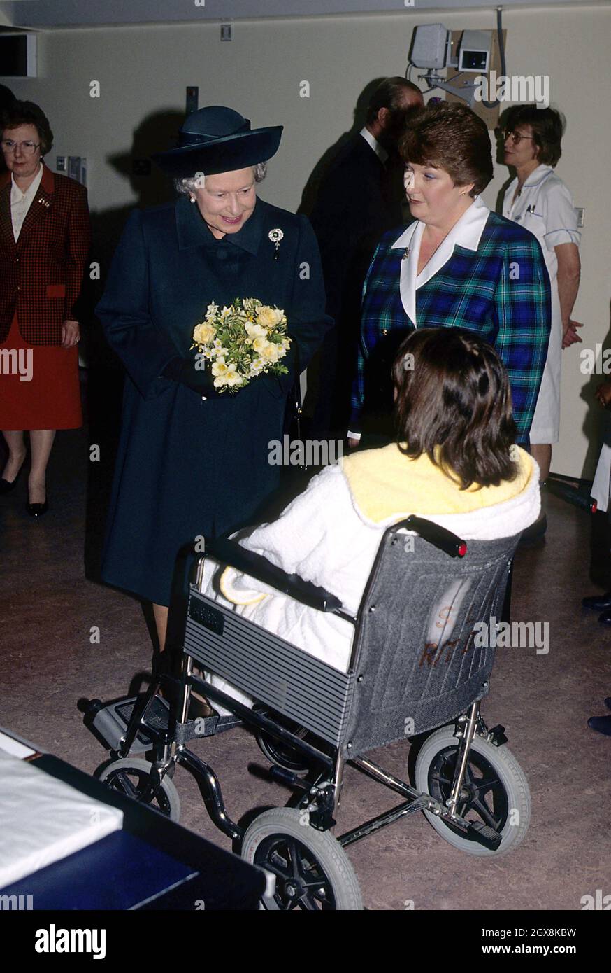 Queen Elizabeth II speaks to patients during her visit to Royal Surrey ...