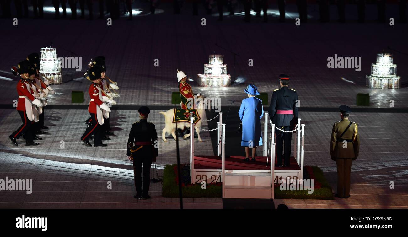 Queen Elizabeth ll watches a march past led by the regimental mascot ...