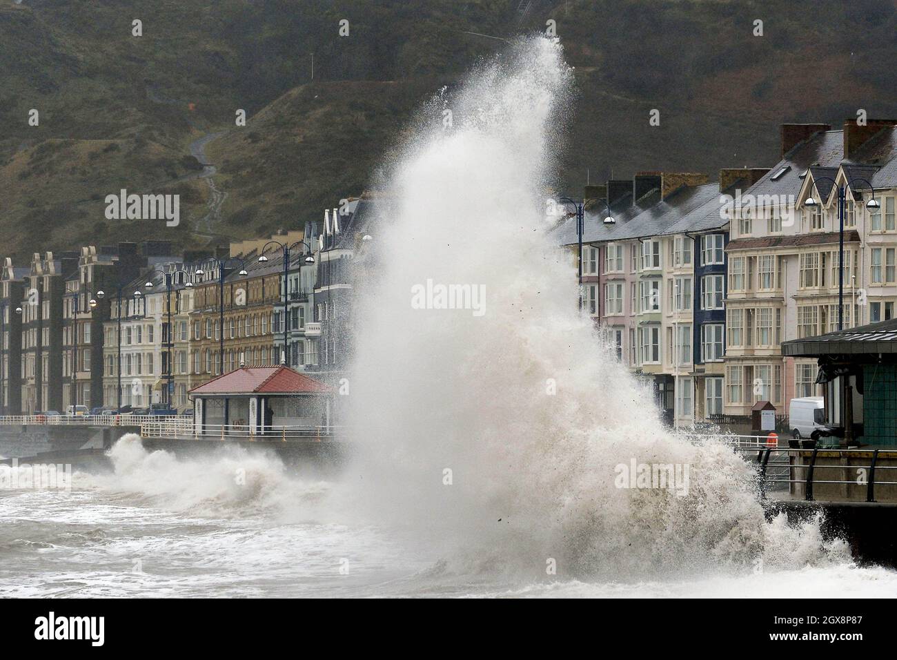 Waves crash against the the promenade in Aberystwyth as huge swathes of ...
