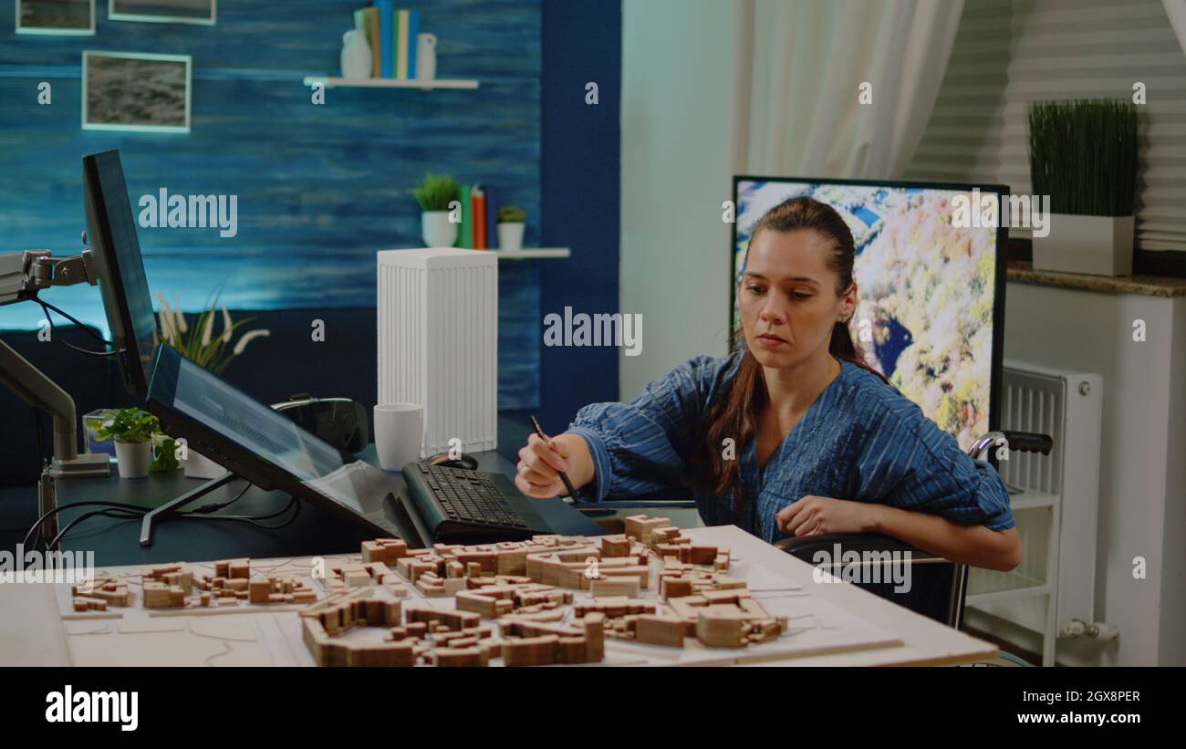Construction engineer with disability working on building design with ...