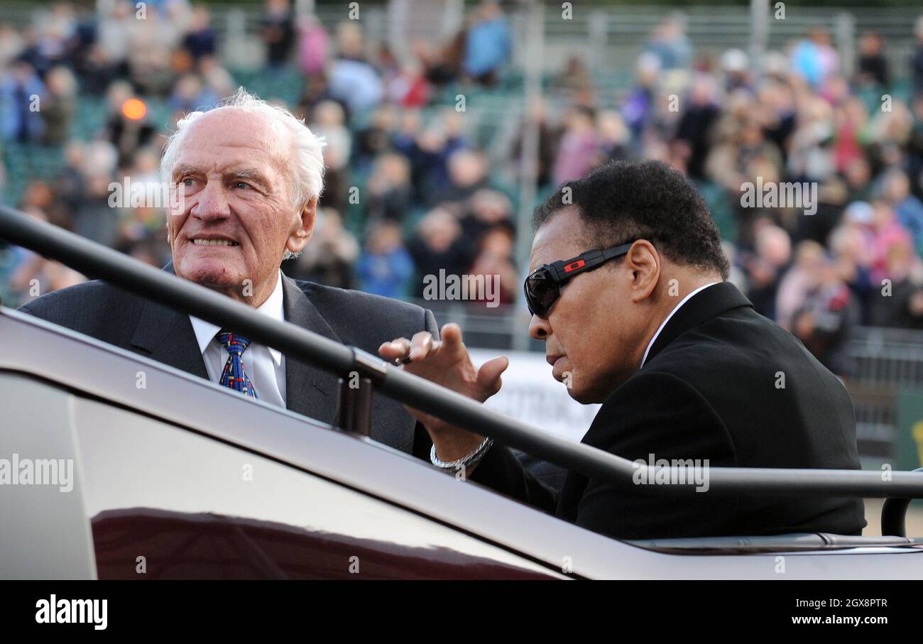 Boxers Muhammad Ali and Sir Henry Cooper parade round the ring in the ...