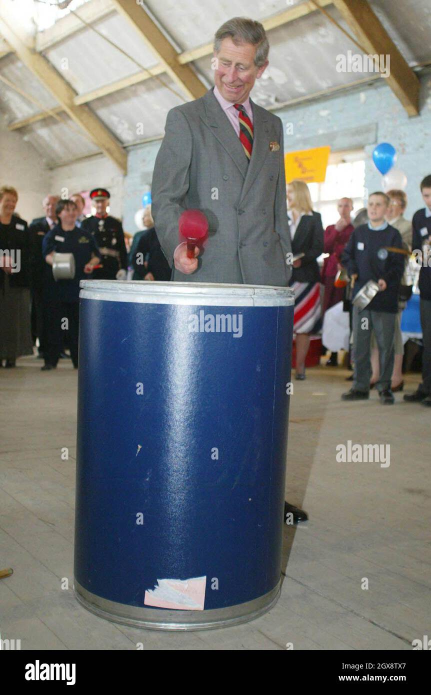 The Prince of Wales, plays on a drum made out of recycled scrap during ...