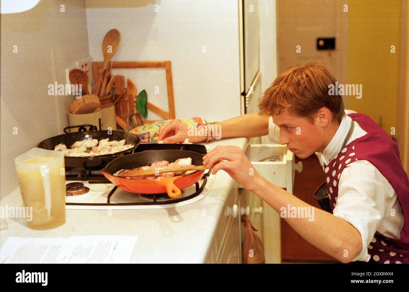 Prince William cooks a chicken paella at Eton in June 2000. Photo ...