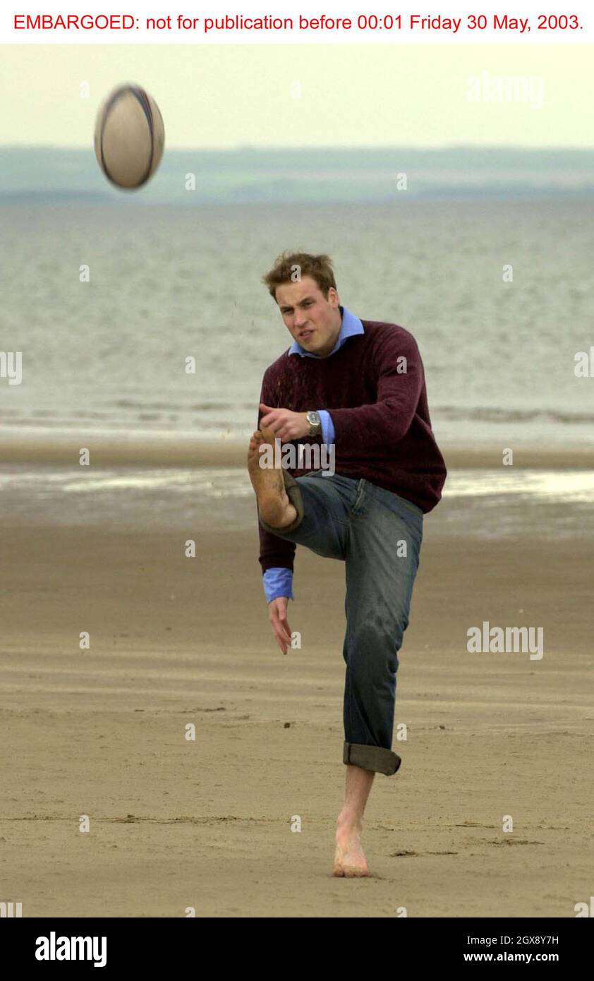 Prince William catches a rugby ball on the beach at St Andrews ...