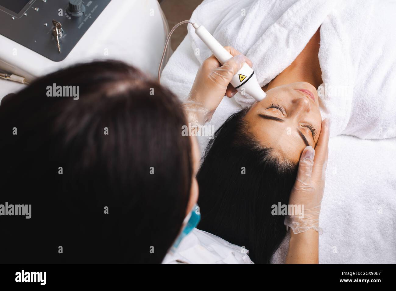 Woman at spa salon cleaning face with apparatus. Skin care. Beauty skin ...