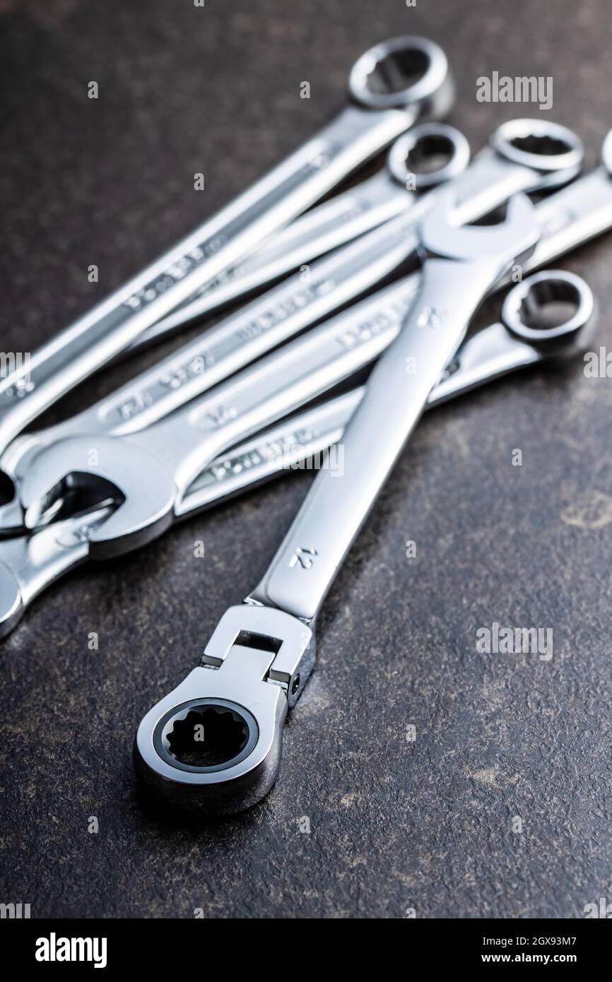 Stainless steel ratchet wrench on black table Stock Photo - Alamy