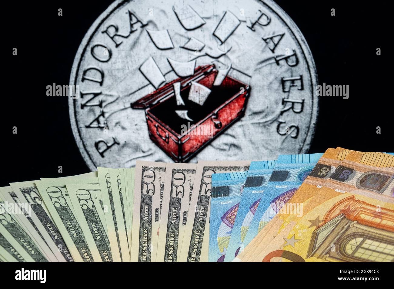 Money and blurred Pandora Papers token, symbol of leaked documents seen ...