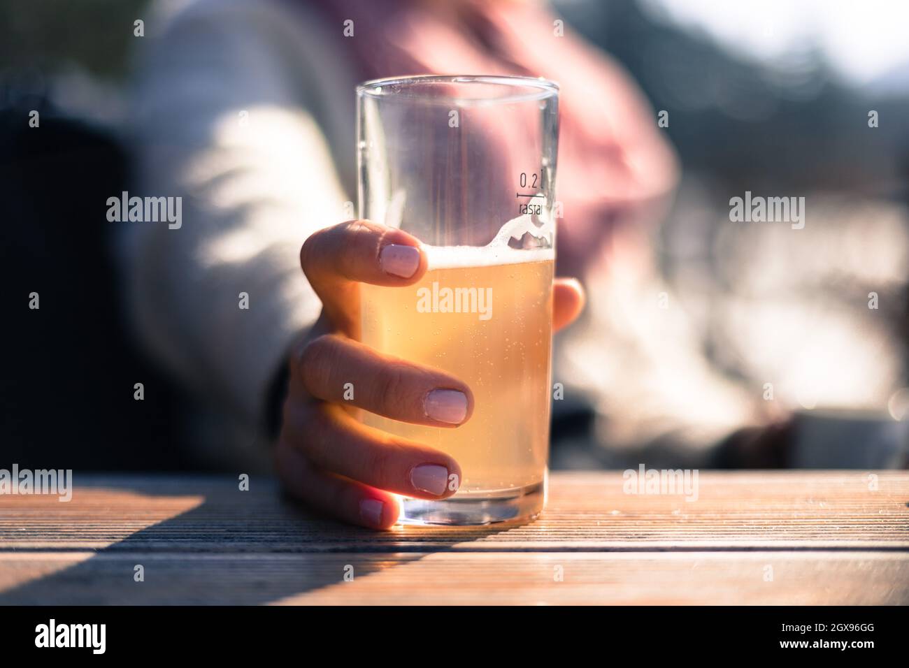 Woman is holding a glass lemonade in her hand, cut-out Stock Photo - Alamy