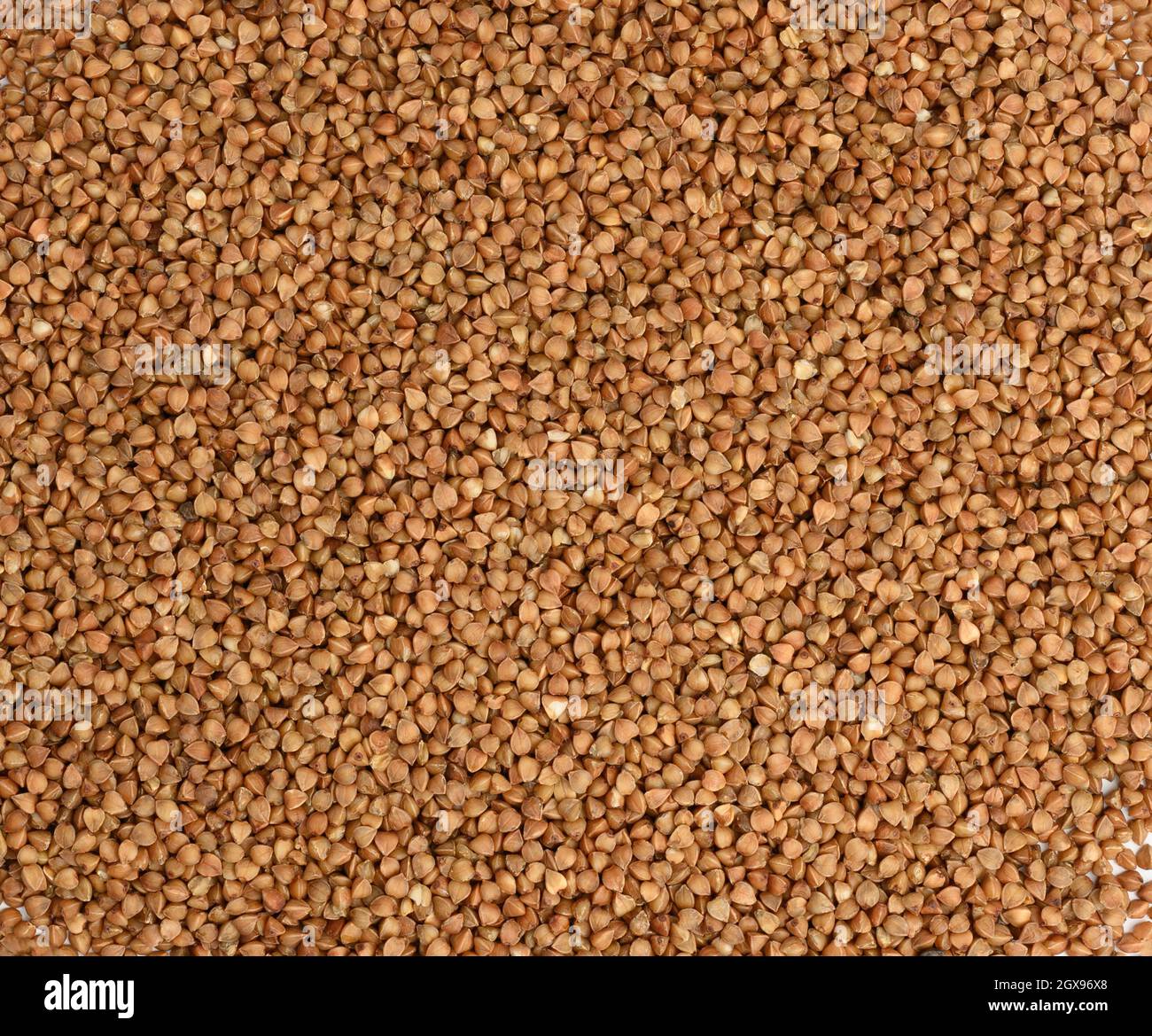 heap of uncooked buckwheat grains, top view. Full frame texture, close ...