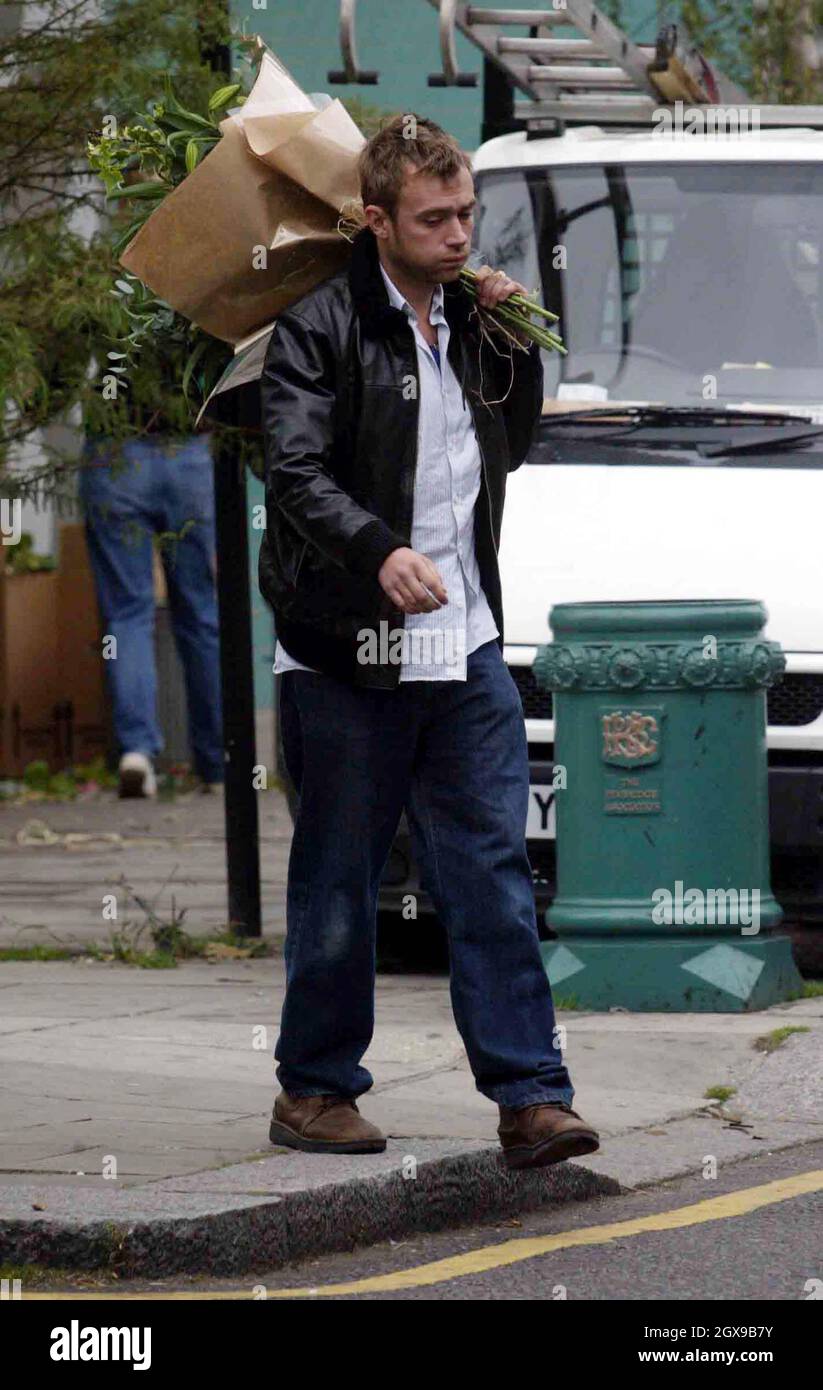Damon Albarn out with his wife and baby daughter buying flowers Stock ...