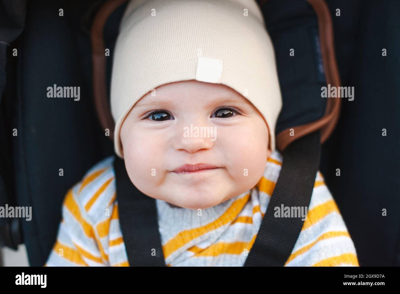 Beautiful portrait of a baby in carriage for lifestyle design. Funny ...