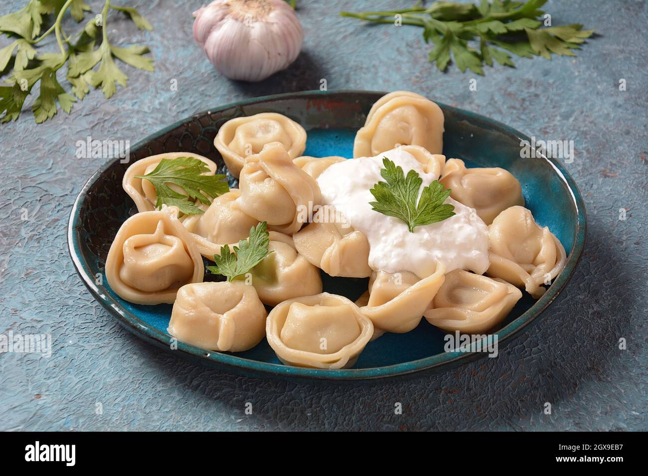 Homemade Meat Dumplings served with sour cream and fresh parsley on ...