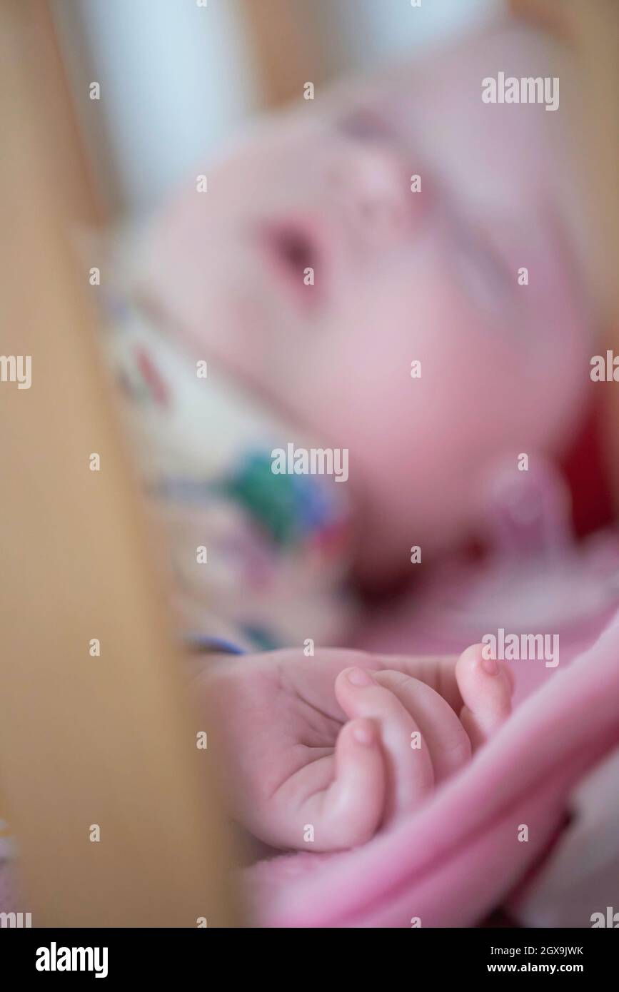 newborn baby girl sleeping in bed at home Stock Photo - Alamy