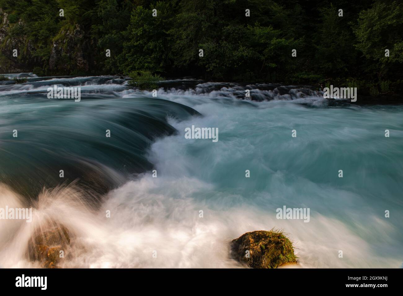 single stone in wild river landscape long exposure photo representing ...