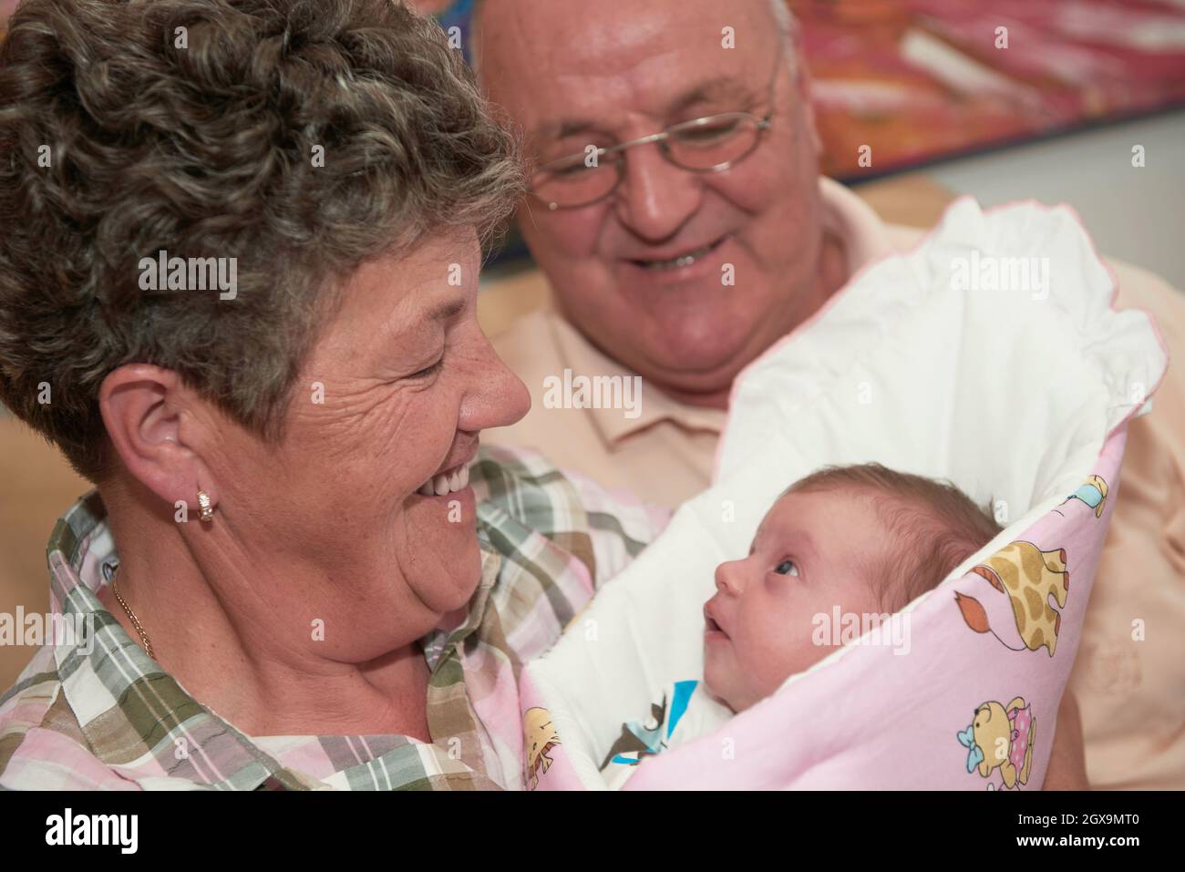 generations family portrait with grandparents parents and newborn baby ...