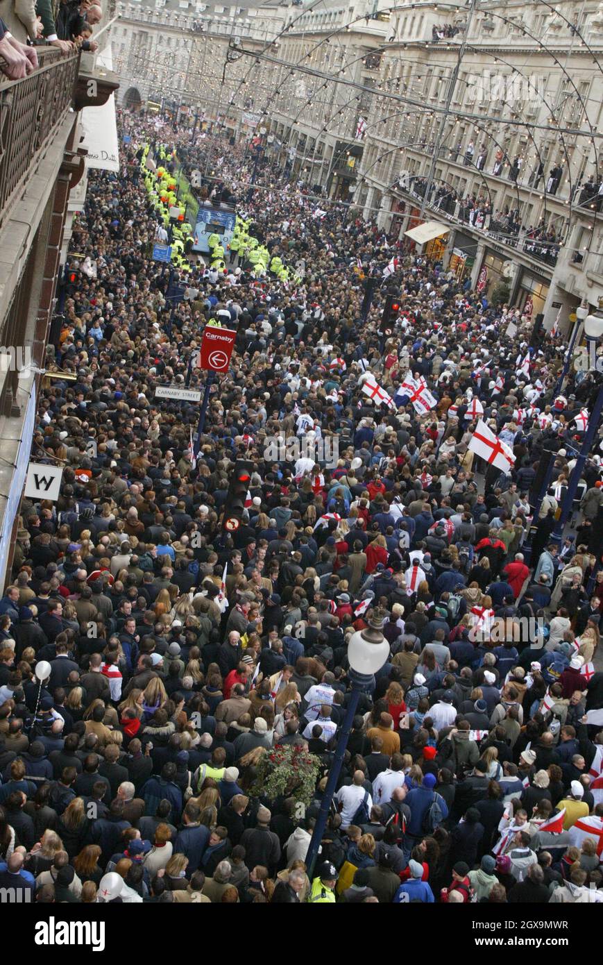The England rugby team bus makes its way through the thousands of ...