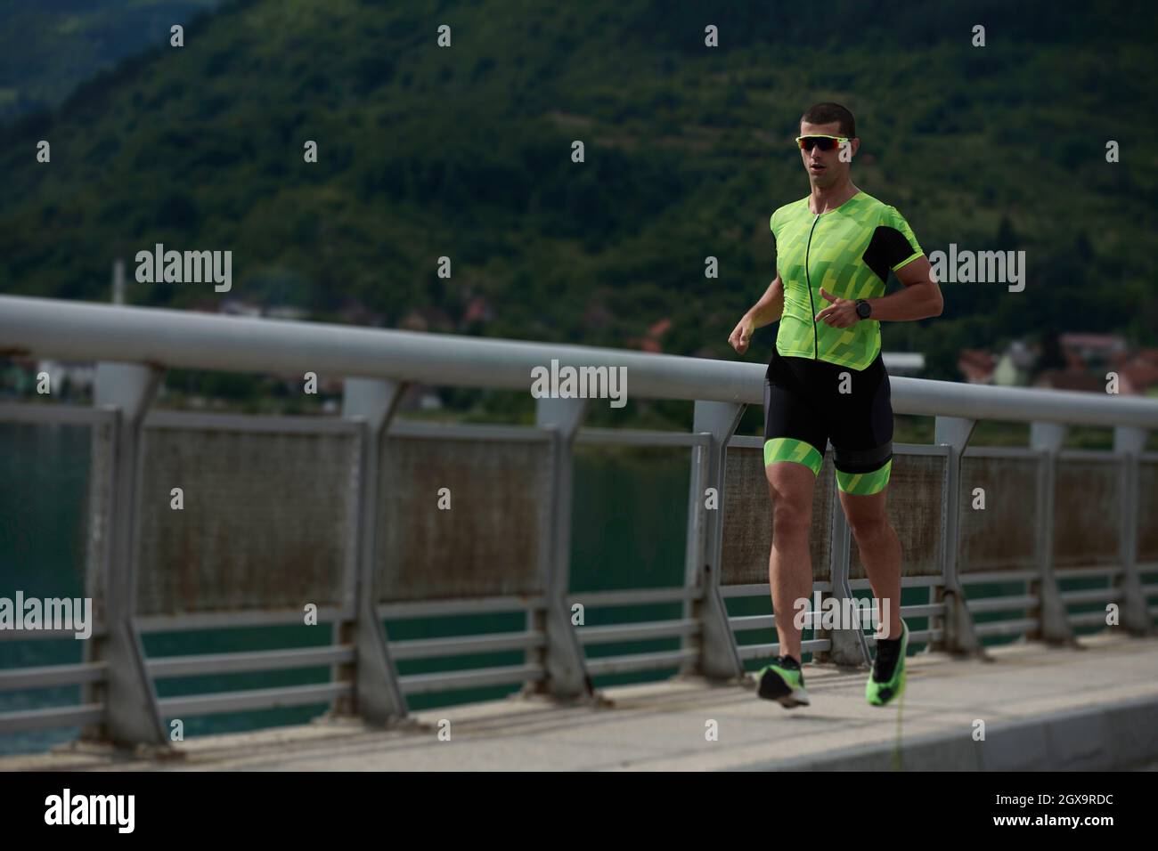 triathlon athlete running on street urban enviroment morning training ...