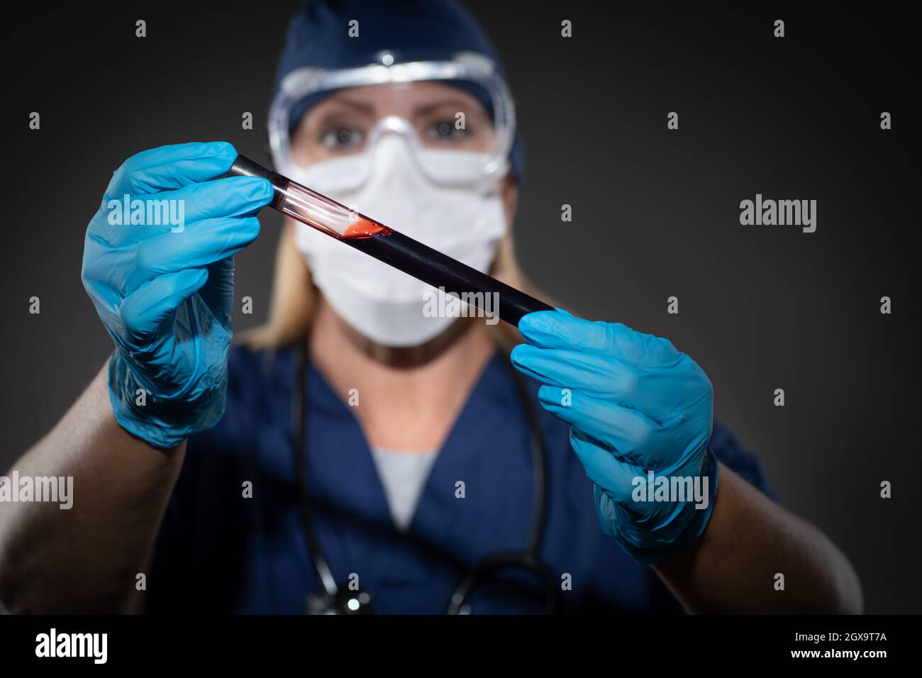 Female Lab Worker Wearing Medical Face Mask Holds Test Tube of Blood ...