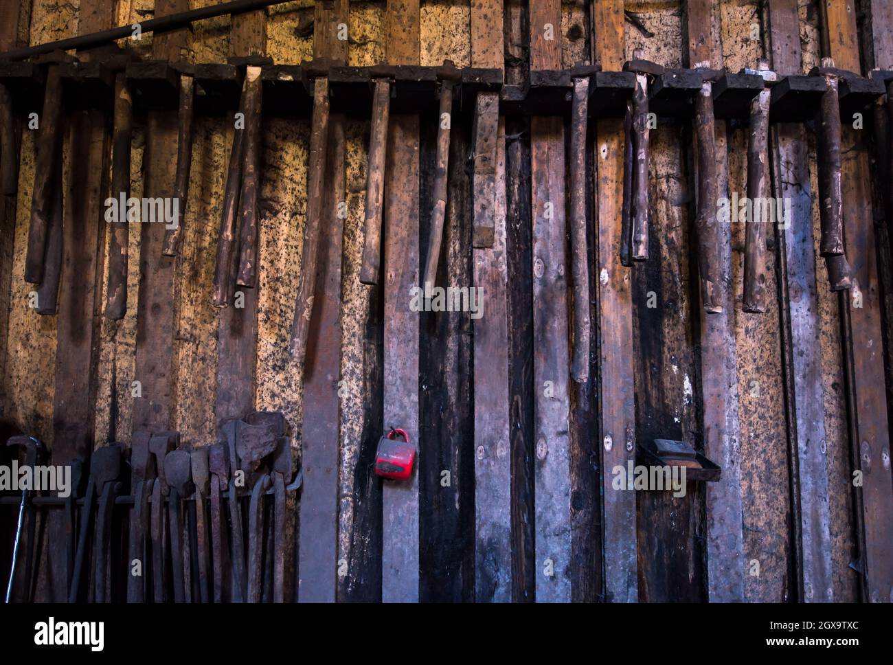 blacksmith tools hanging on a wooden wall Stock Photo - Alamy