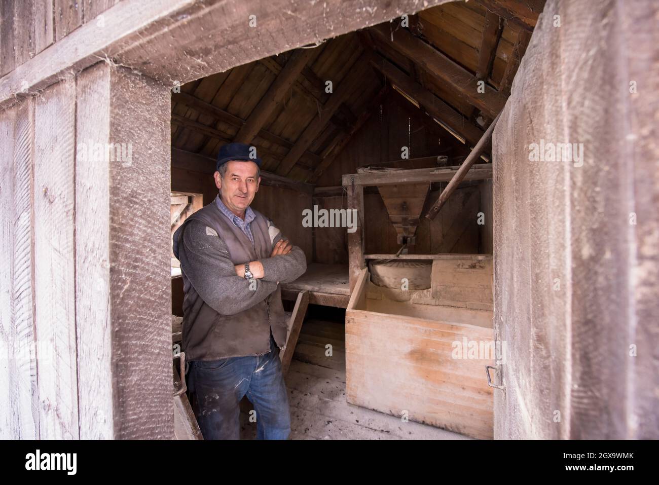 portrait of a miller in retro wooden watermill with old equipment Stock ...