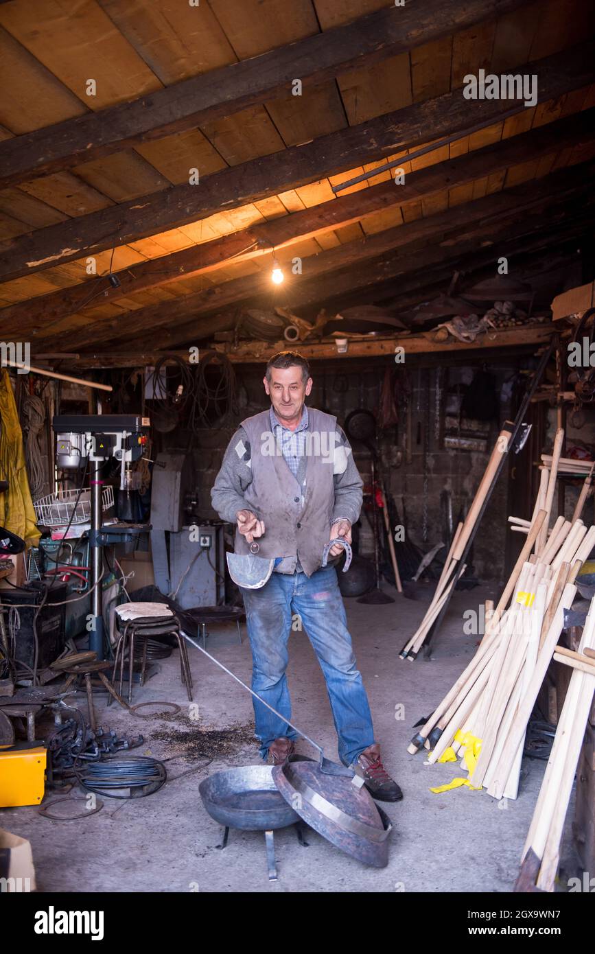 blacksmith traditional workshop A blacksmith worker showing forged iron ...