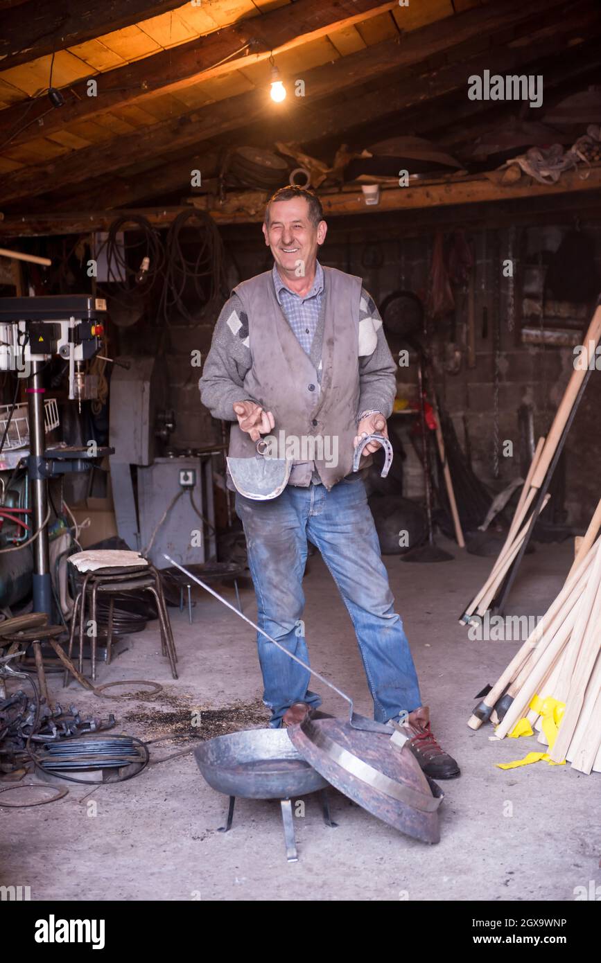 blacksmith traditional workshop A blacksmith worker showing forged iron ...
