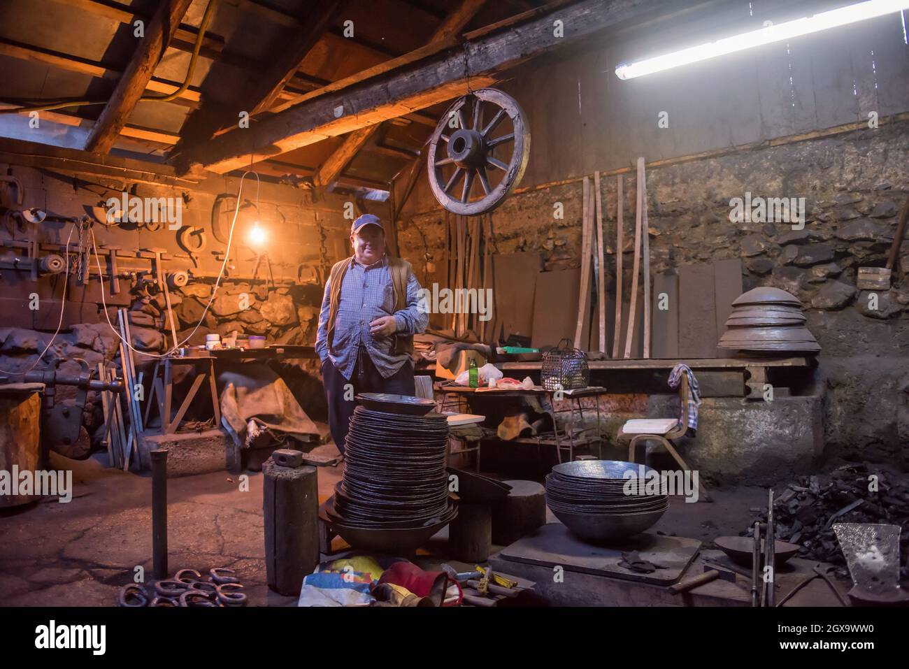 portrait of confident senior blacksmith during a break from work at ...
