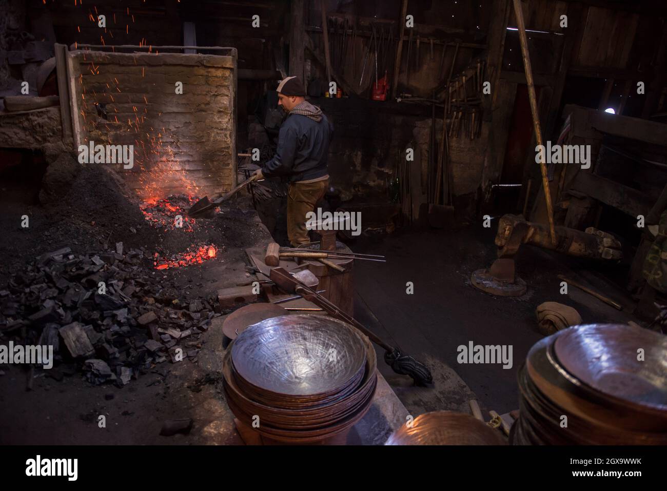 young traditional Blacksmith working with open fire The blacksmith ...