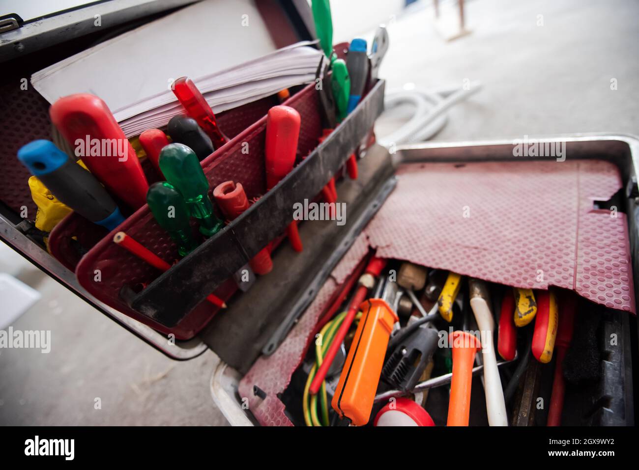toolbox full of hand tools on real dusty floor background at ...