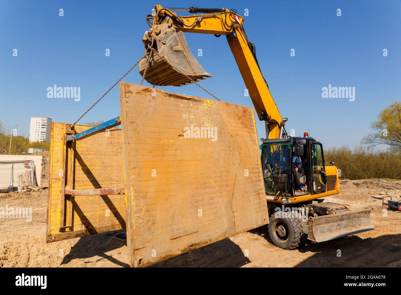 Installation of metal supports to protect the walls of the trench. The ...