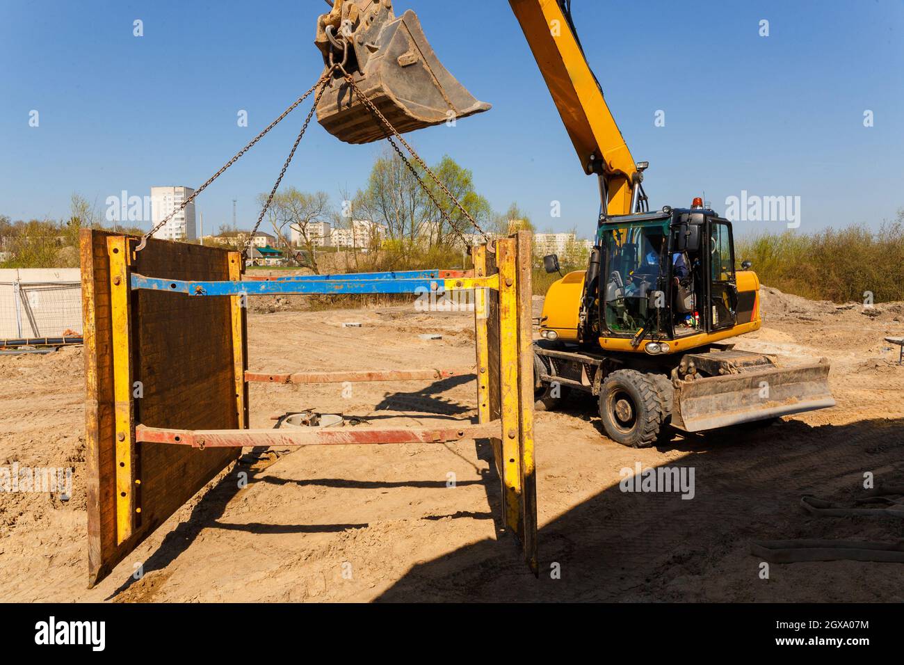 Installation of metal supports to protect the walls of the trench. The ...