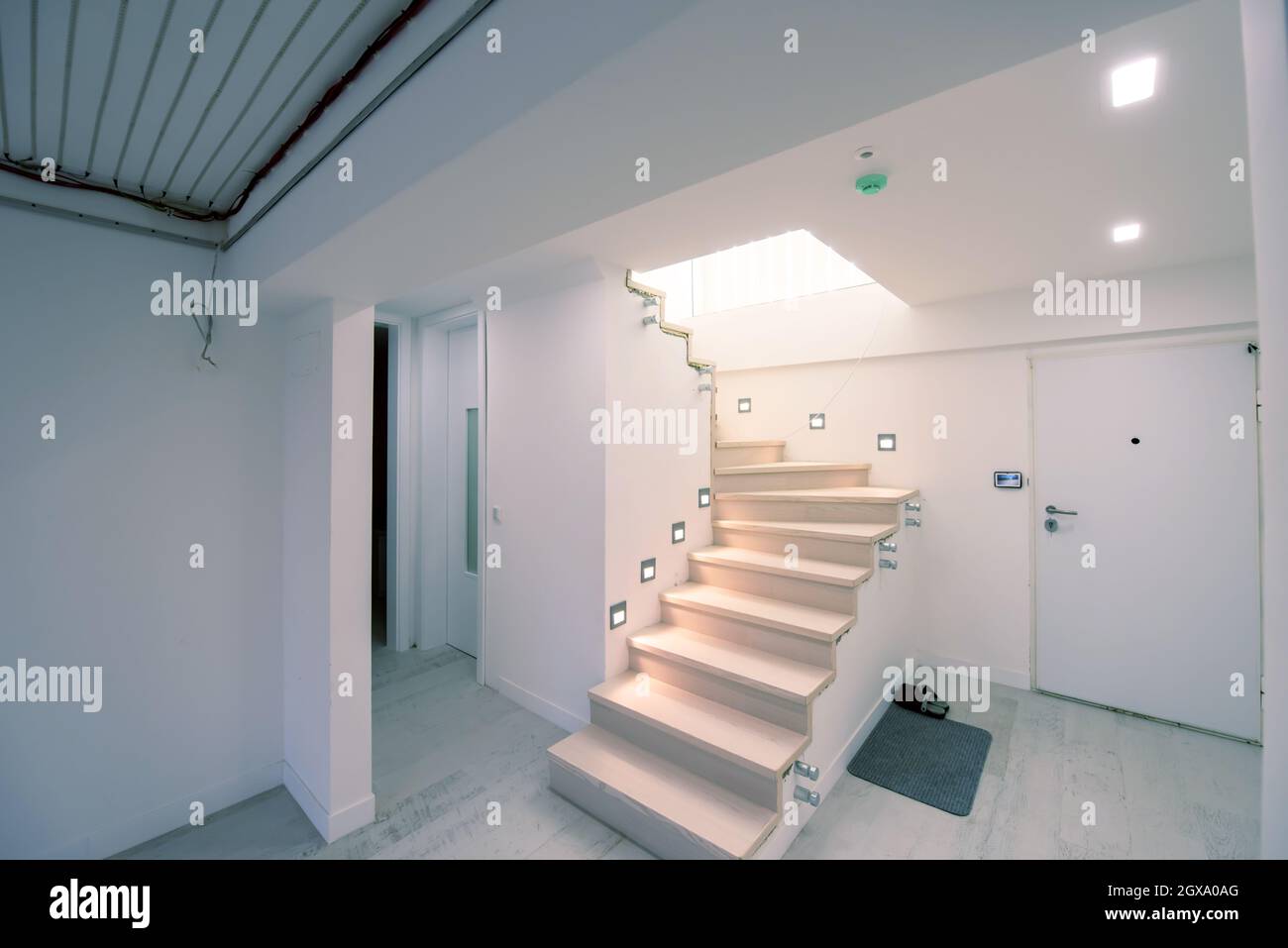 stylish interior with wooden stairs in big modern two level luxury ...