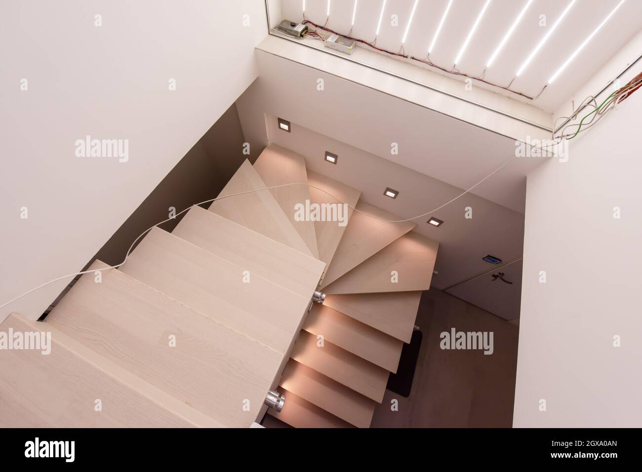 stylish interior with wooden stairs in big modern two level luxury ...