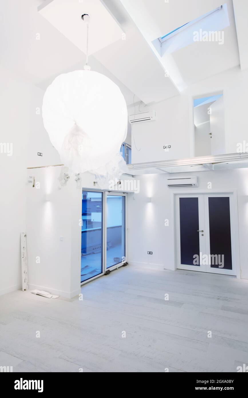 Interior of empty stylish modern open space two level apartment with ...