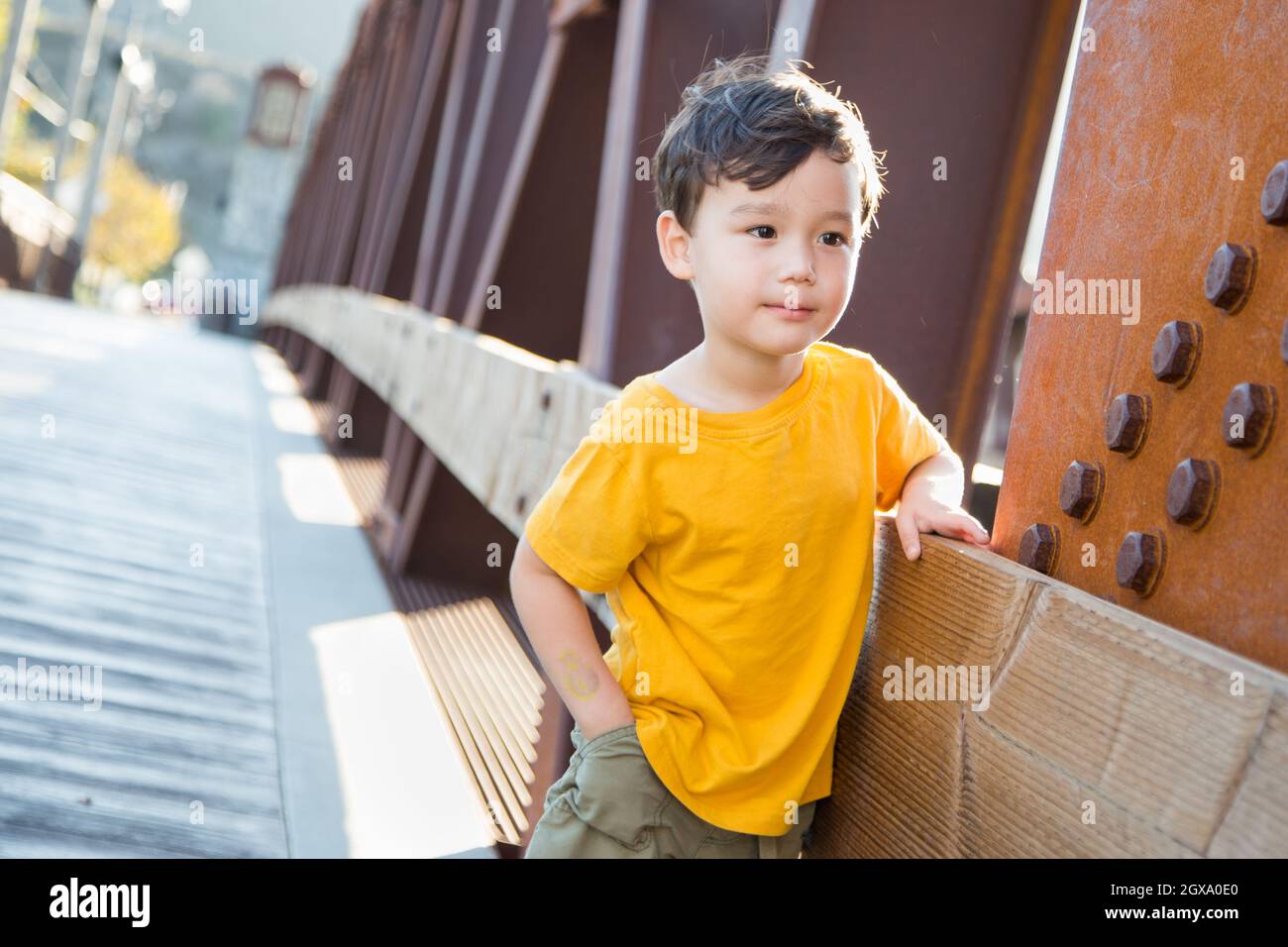Mixed Race Chinese and Caucasian Boy Playing Alone on Bridge Stock ...