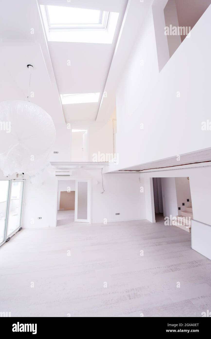 Interior of empty stylish modern open space two level apartment with ...