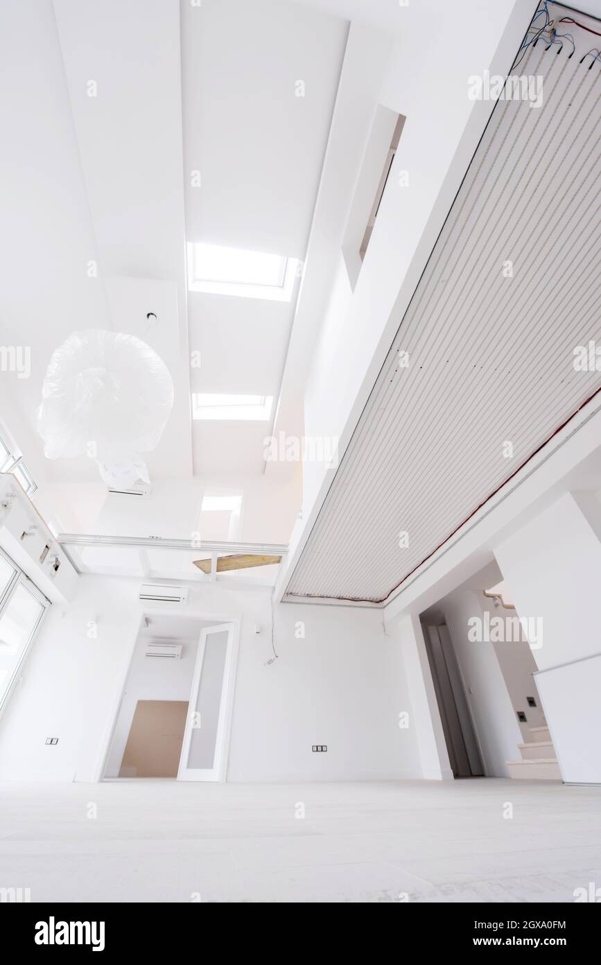 Interior of empty stylish modern open space two level apartment with ...