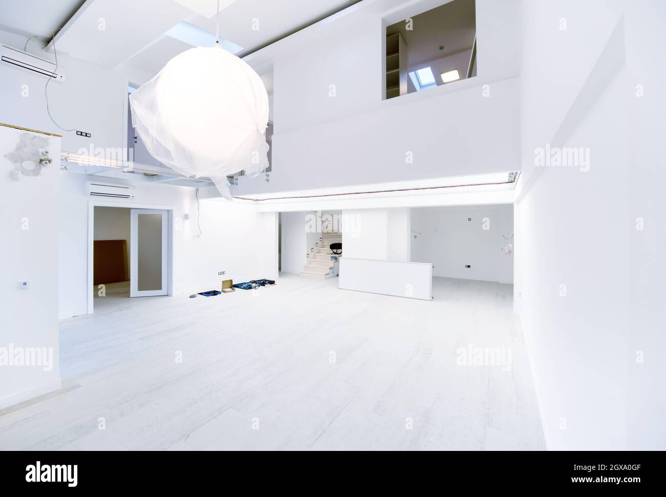 Interior of empty stylish modern open space two level apartment with ...