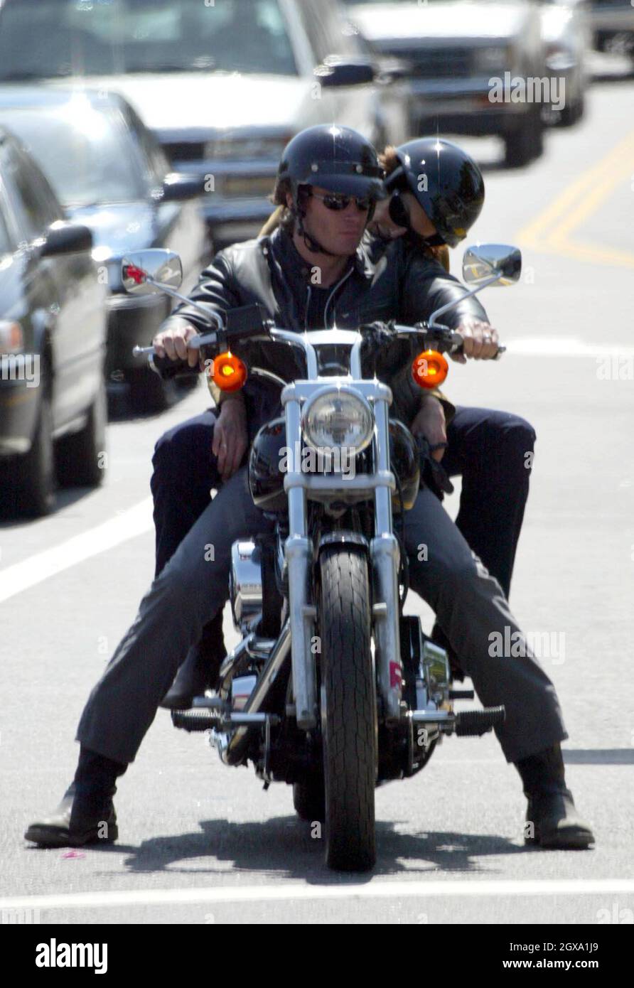 Cindy Crawford and husband Rande Gerber arrive on a motorbike to view the Malibu beach house ...