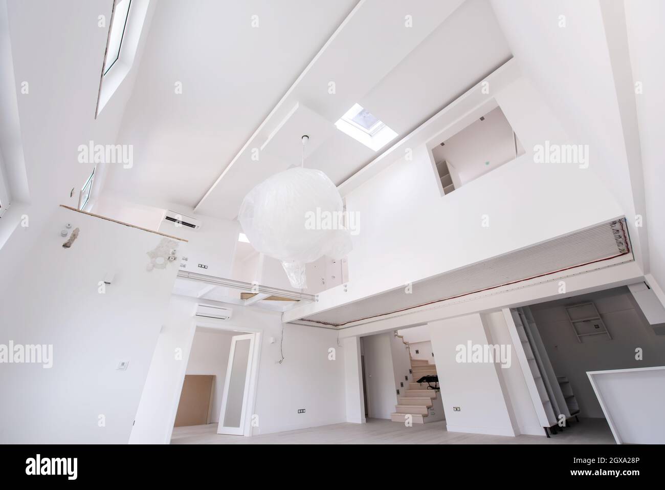 Interior of empty stylish modern open space two level apartment with ...