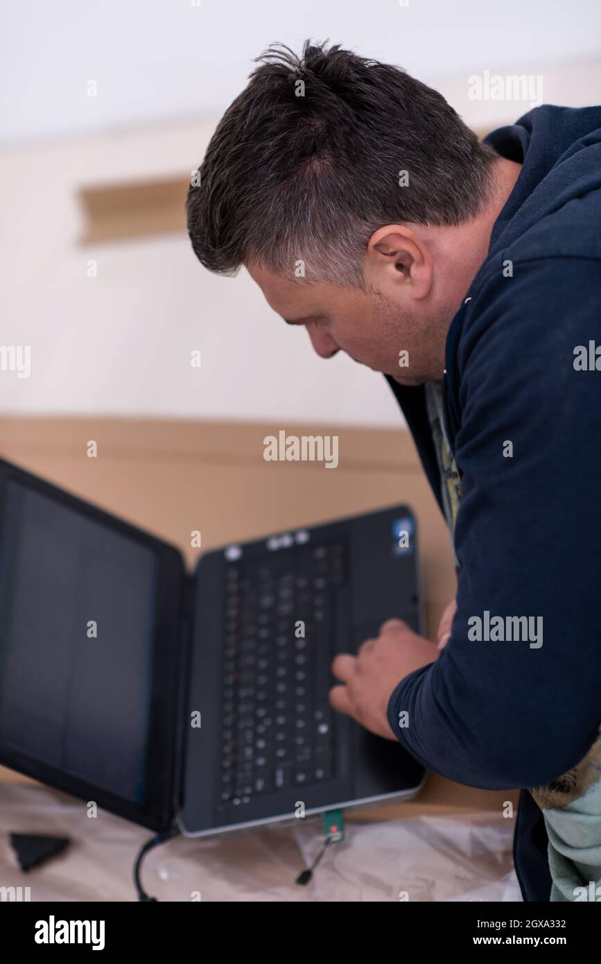 man checking business workflow using laptop computer while lying on ...