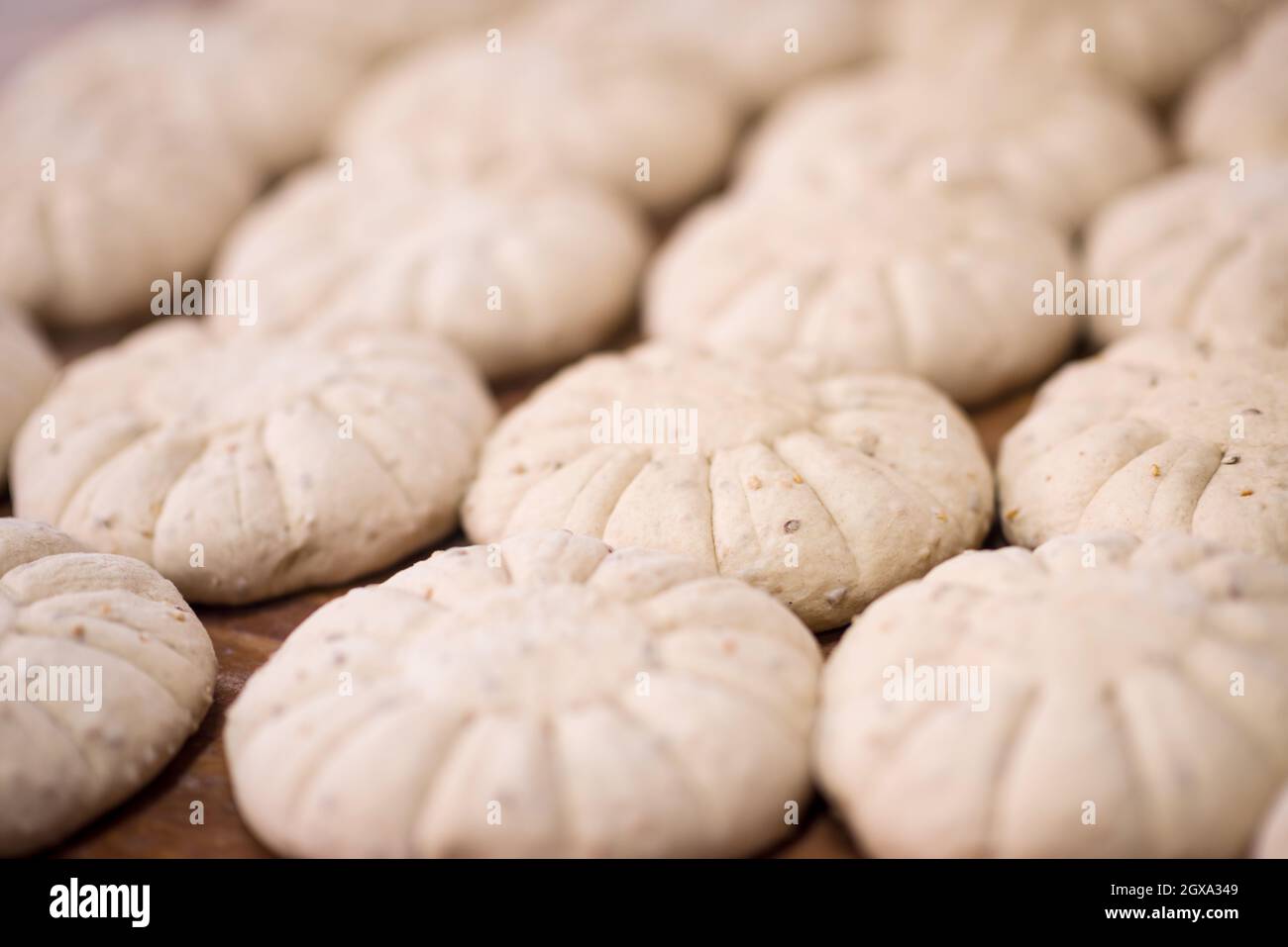 balls of dough bread getting ready to be baked at professional bakery ...
